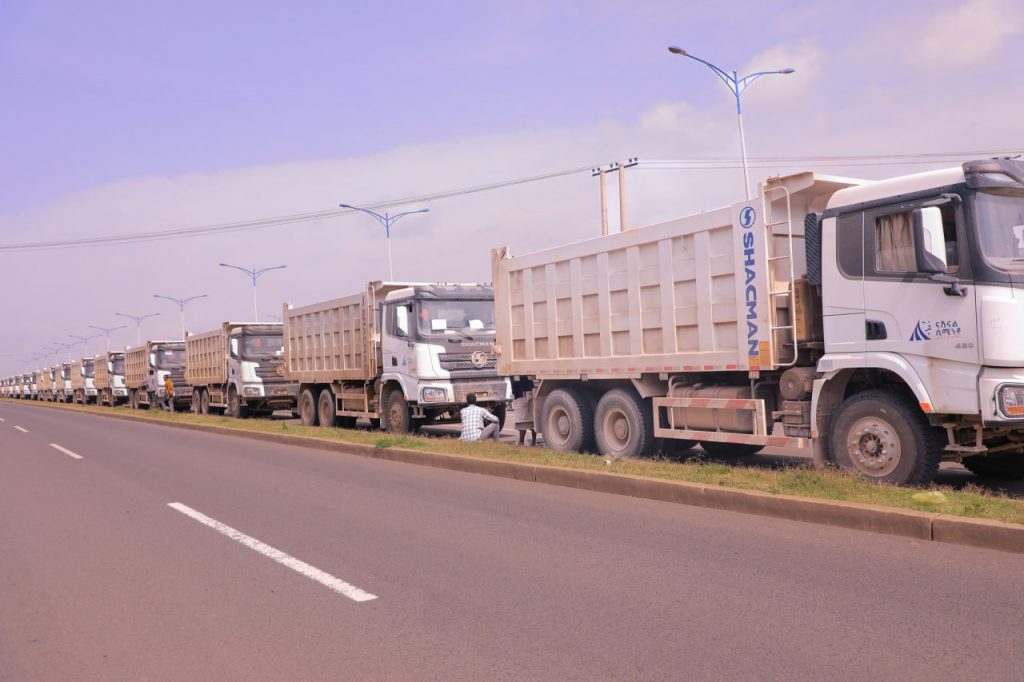Modern trucks arrive at project site to facilitate material transport ...